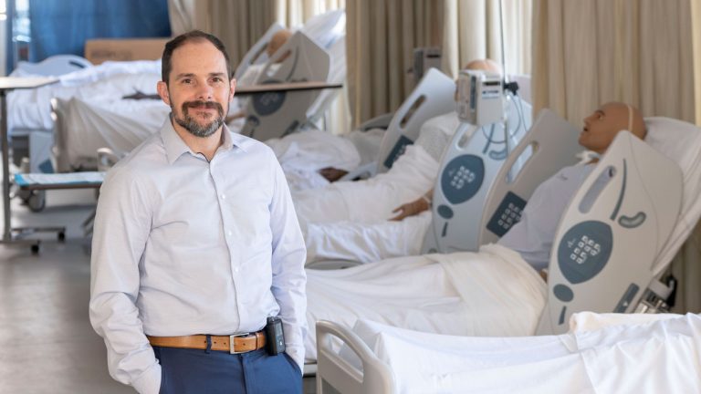 Nursing Assistant Teaching Professor Joshua Minks helps support ...